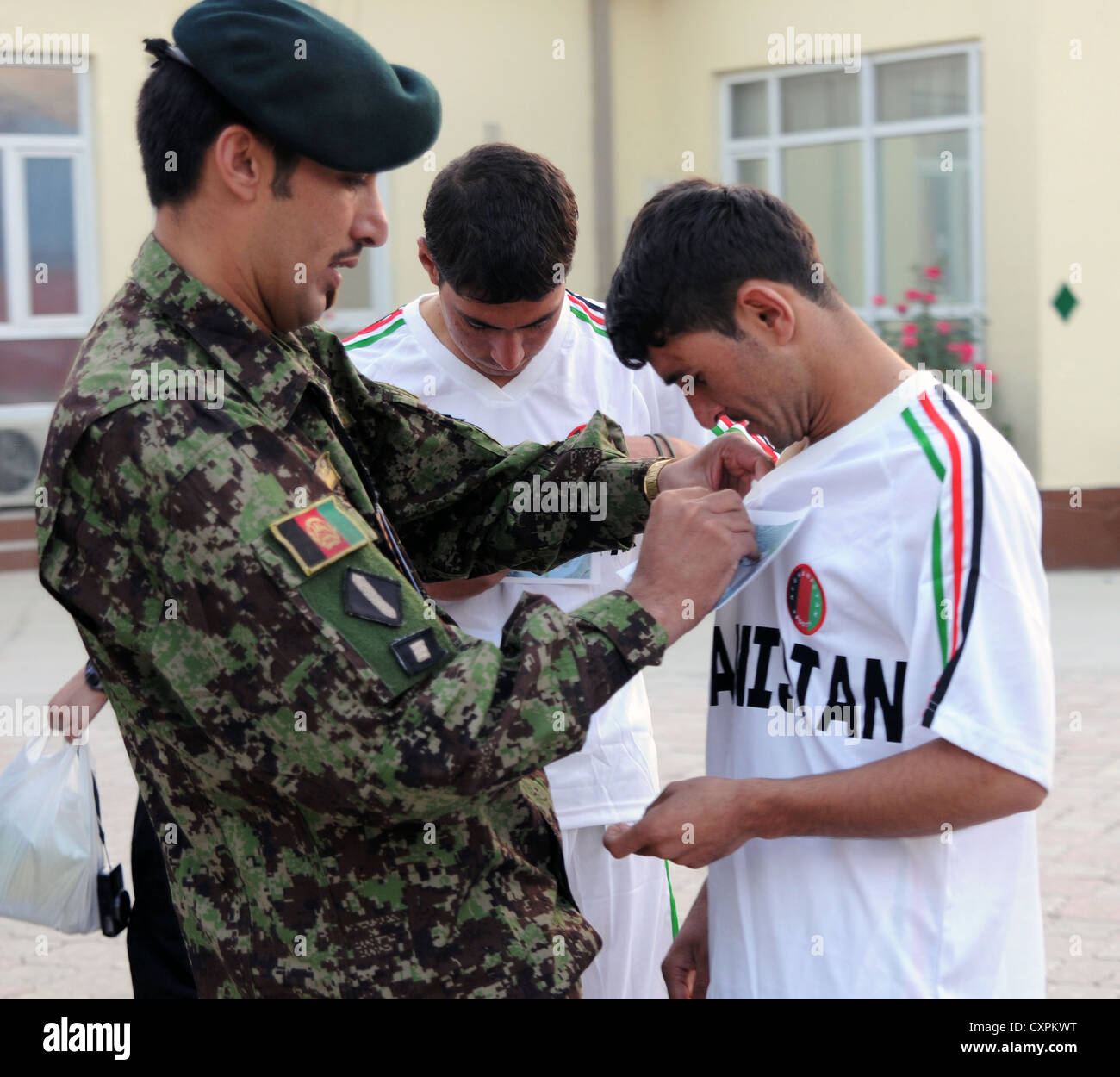 Afghan National Army Command Sgt. Maj. Muhebullah prepares a soldier ...