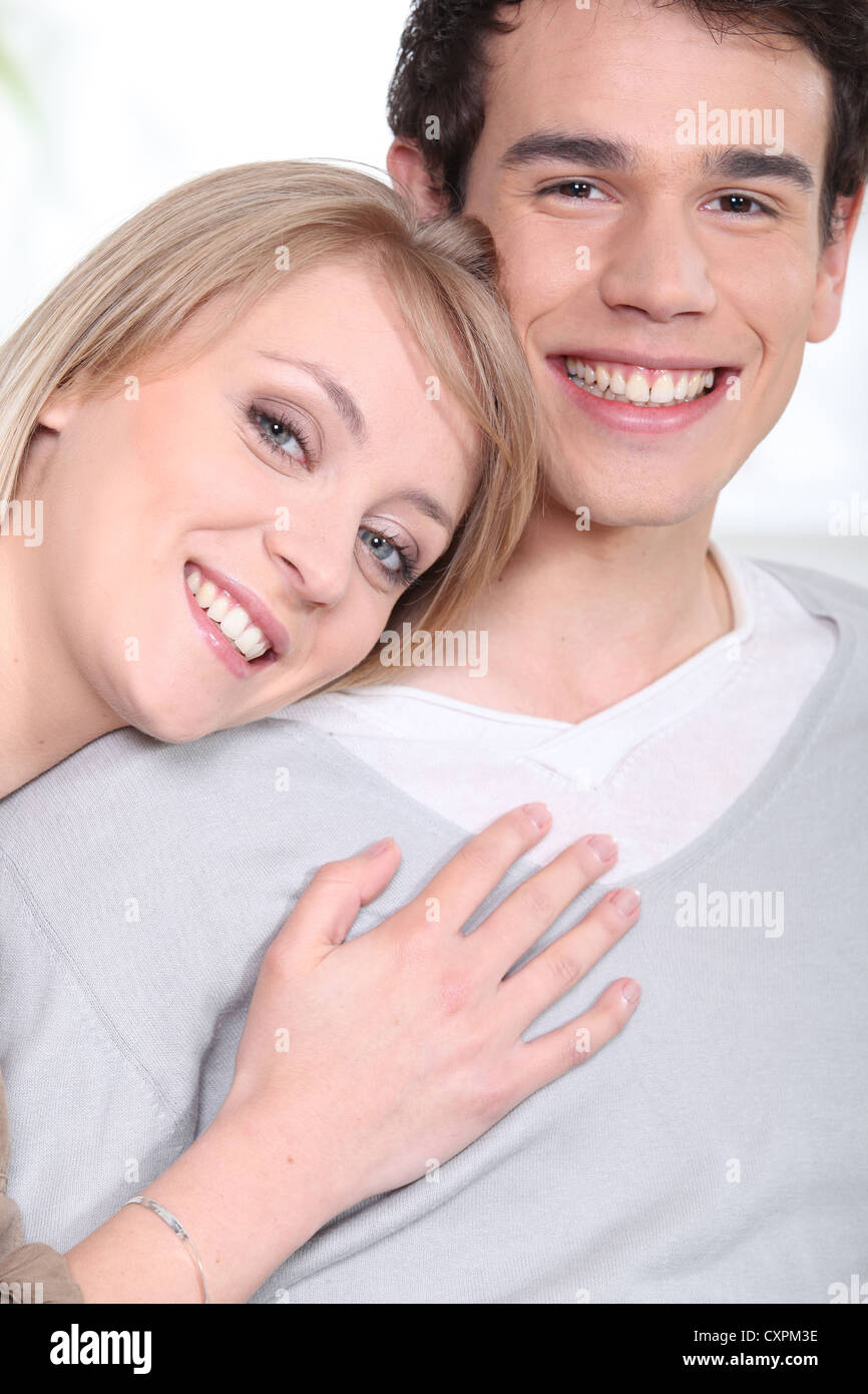 Woman hugging her boyfriend Stock Photo - Alamy