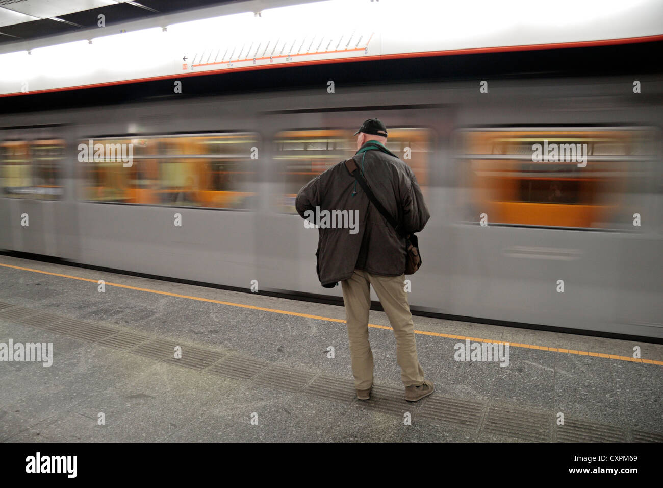 A man on the Austrian Metro system, Vienna, standing on a platform as a ...