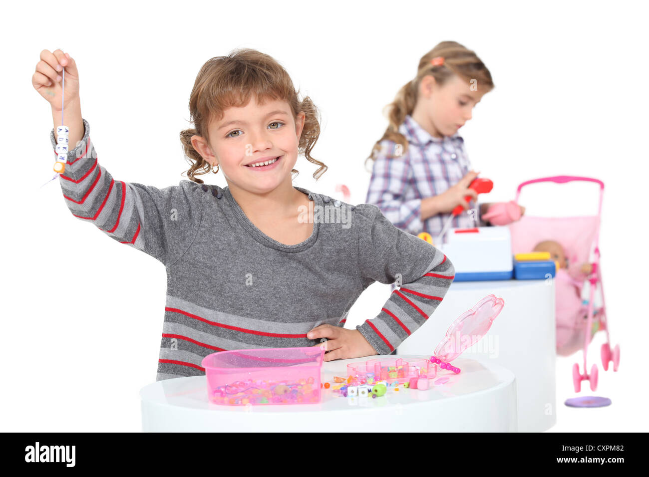 Girls playing with their toys Stock Photo - Alamy