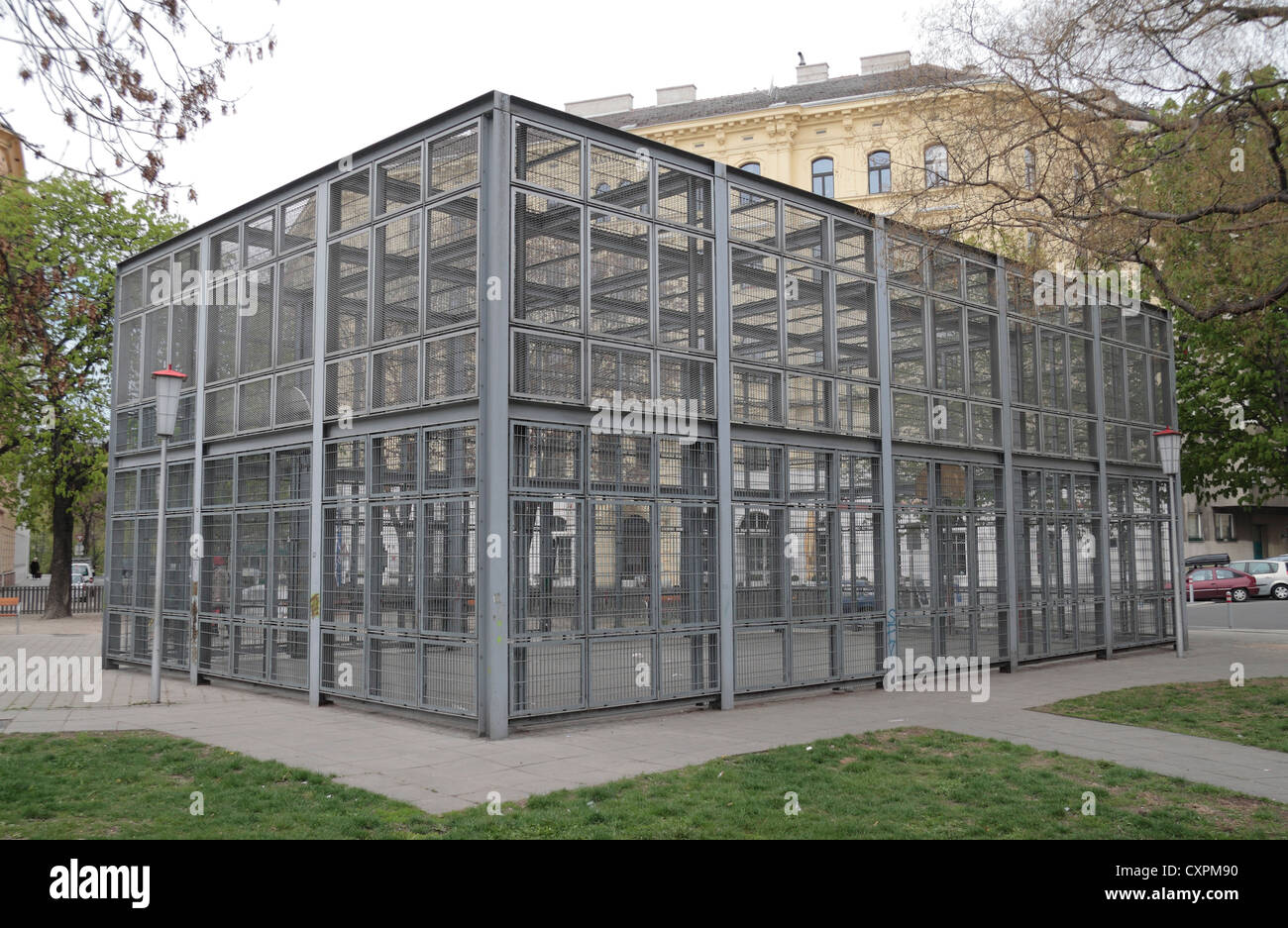 A scary looking cage/playground for children to play in on a street ...