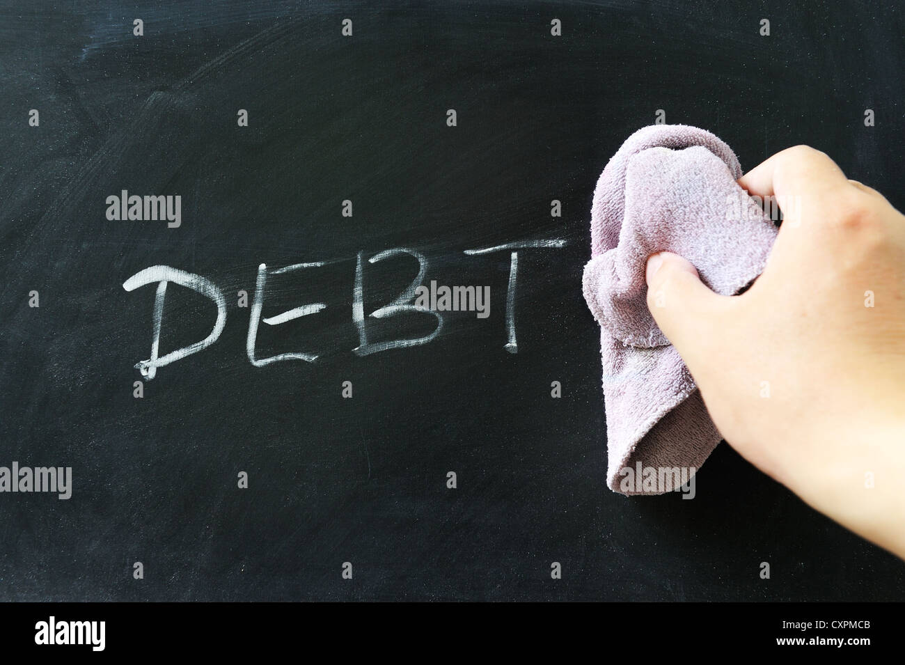 Hand wiping off debt word using rag Stock Photo - Alamy