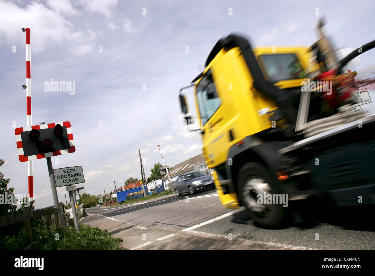 Truck approaching level crossing Stock Photo - Alamy