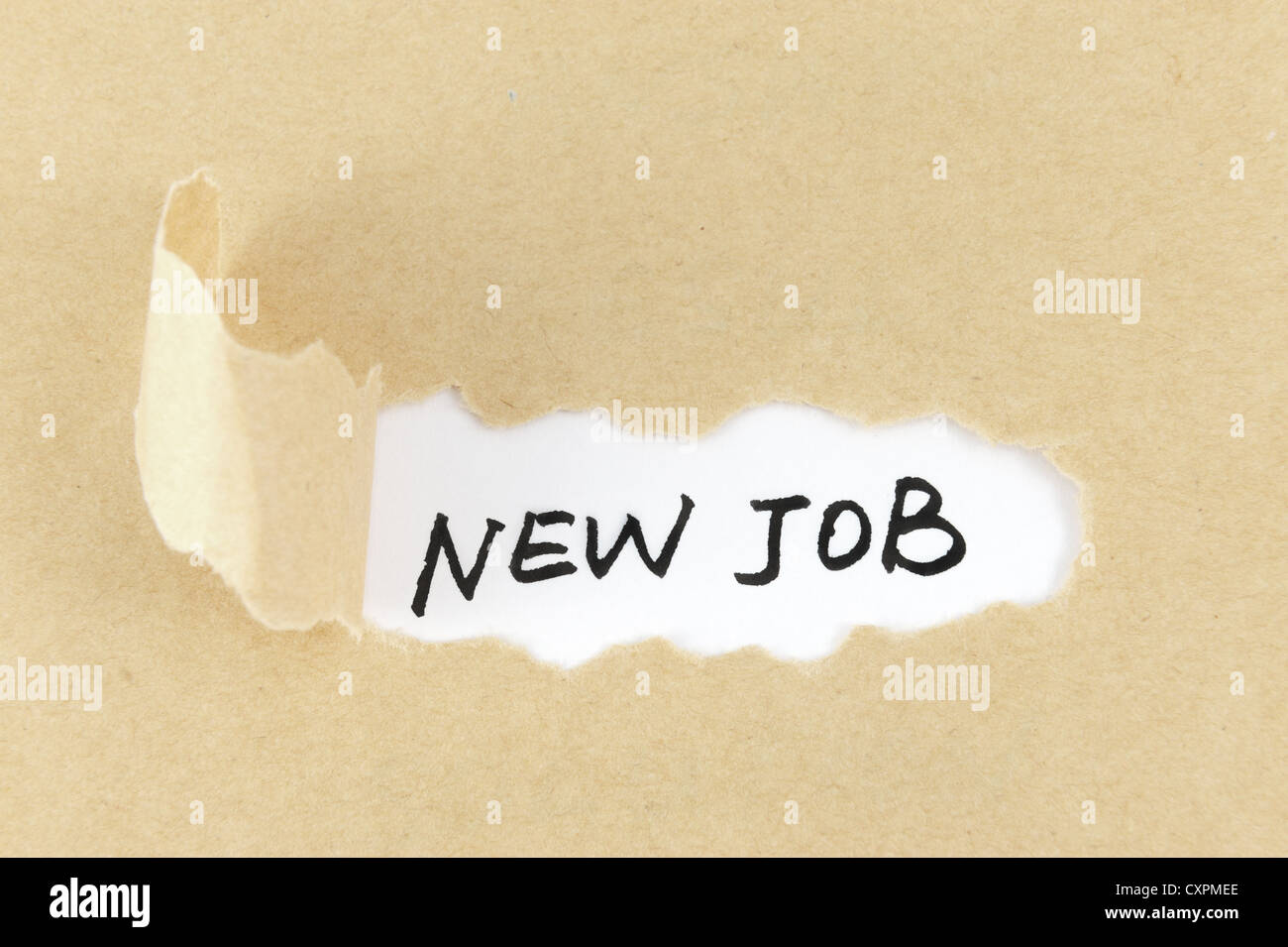 Torn paper with new job words behind it Stock Photo - Alamy