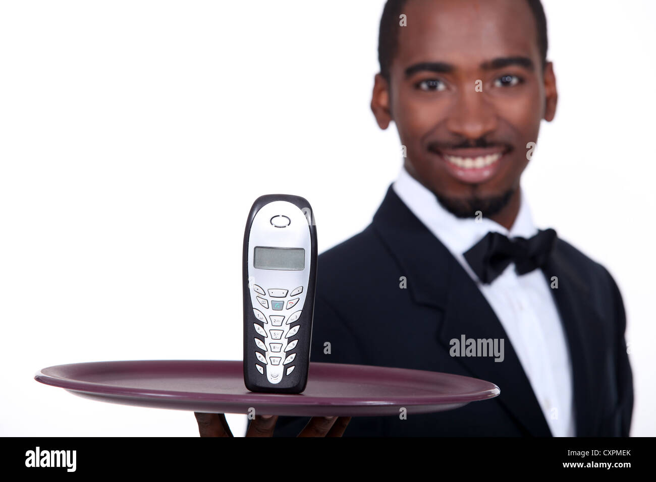 black waiter showing a phone Stock Photo - Alamy