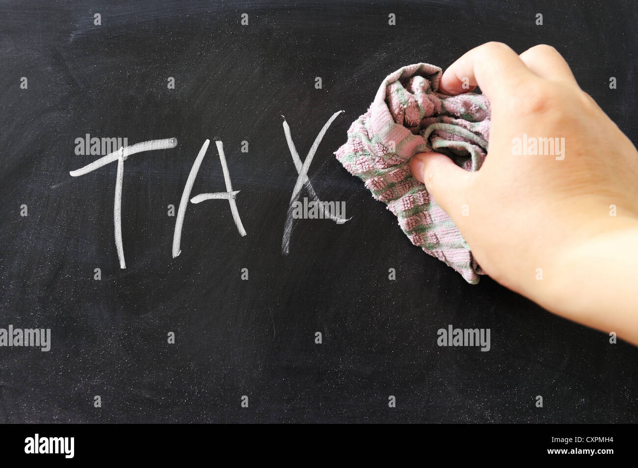 Hand wiping off tax word using rag Stock Photo - Alamy