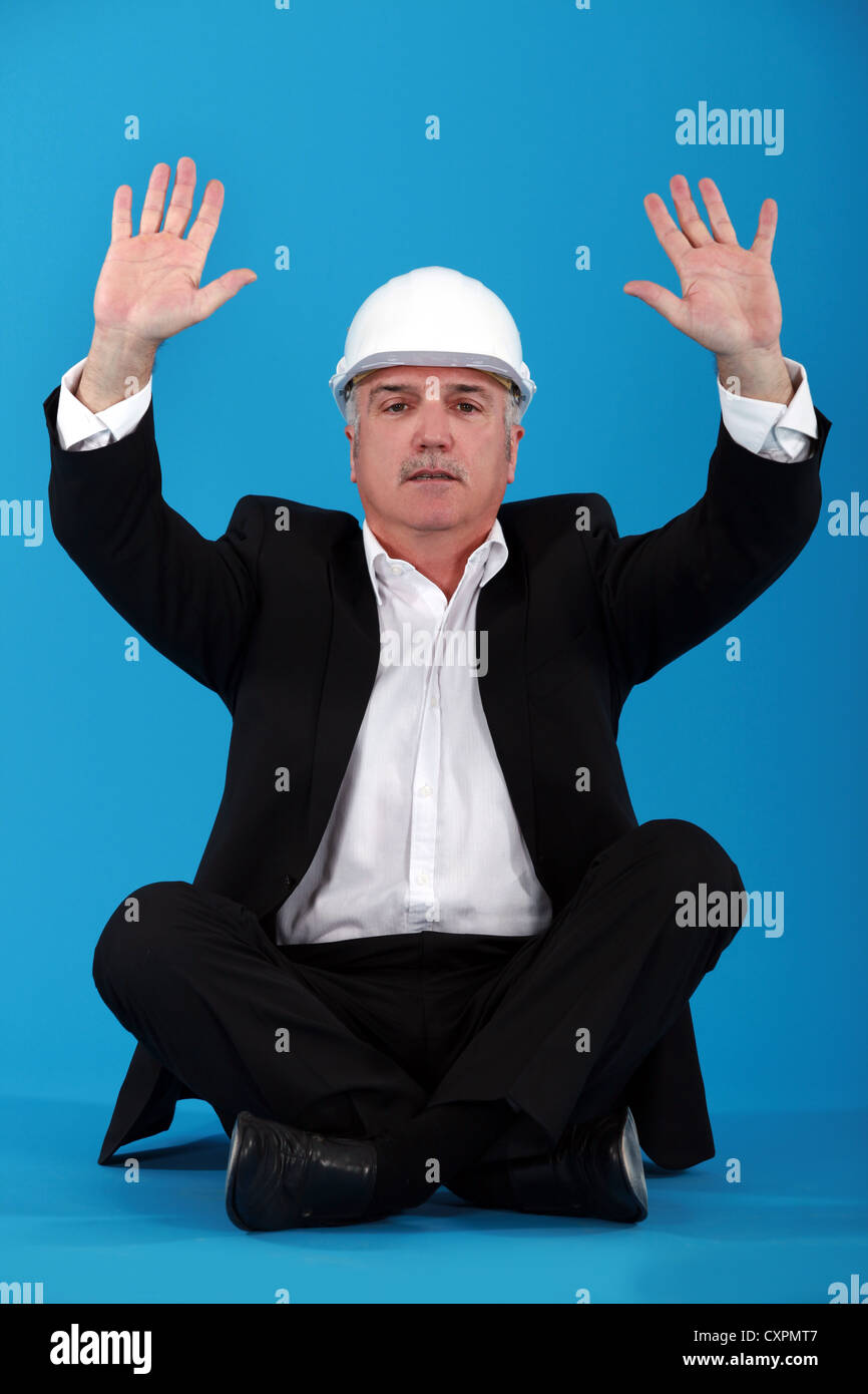 Senior architect sat making stop gesture Stock Photo - Alamy