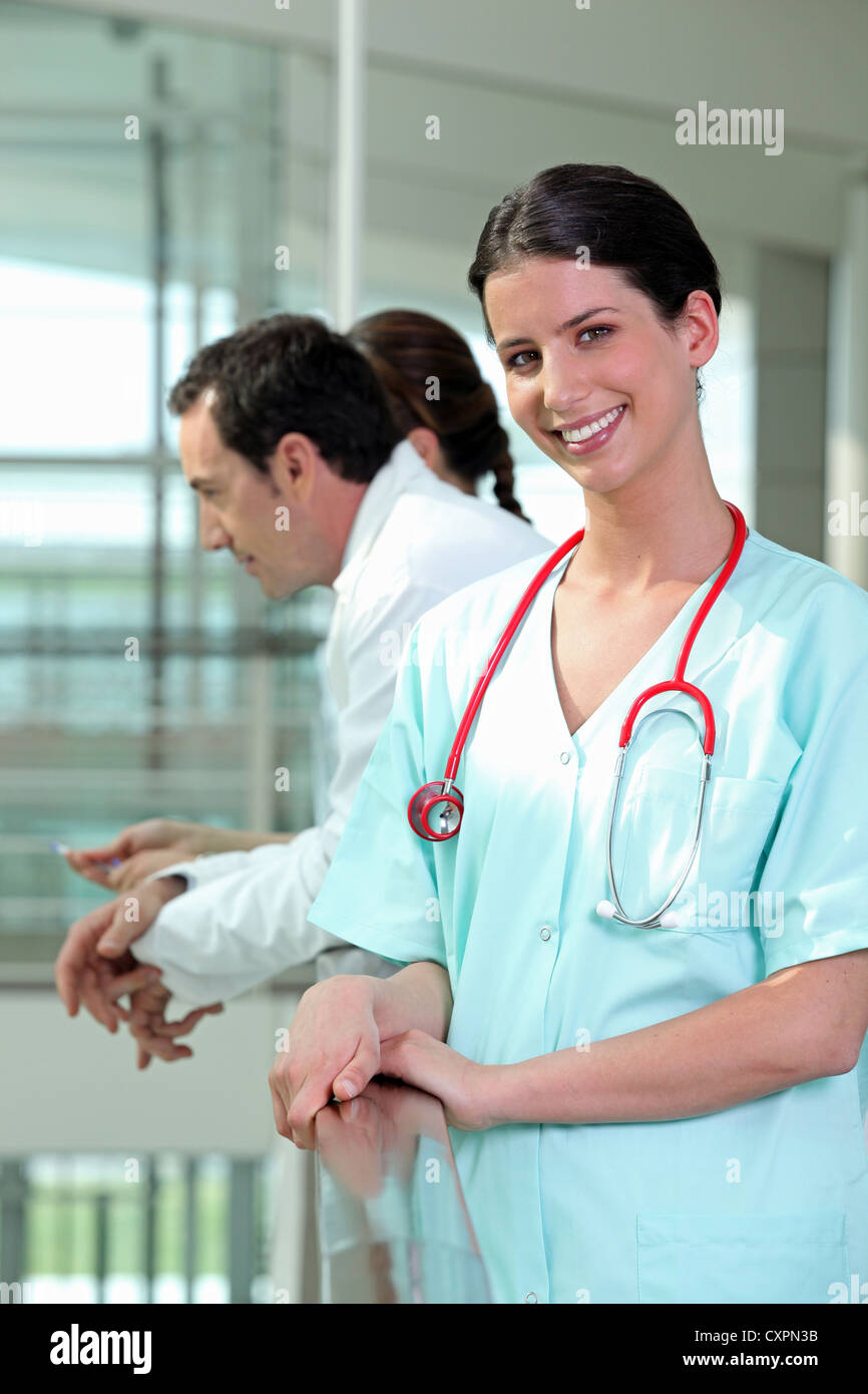 Smiling nurse standing with colleagues Stock Photo - Alamy
