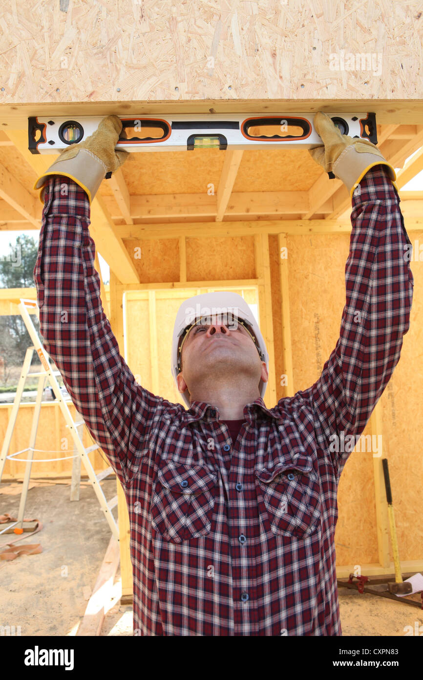 Man using spirit level to check woodwork Stock Photo - Alamy