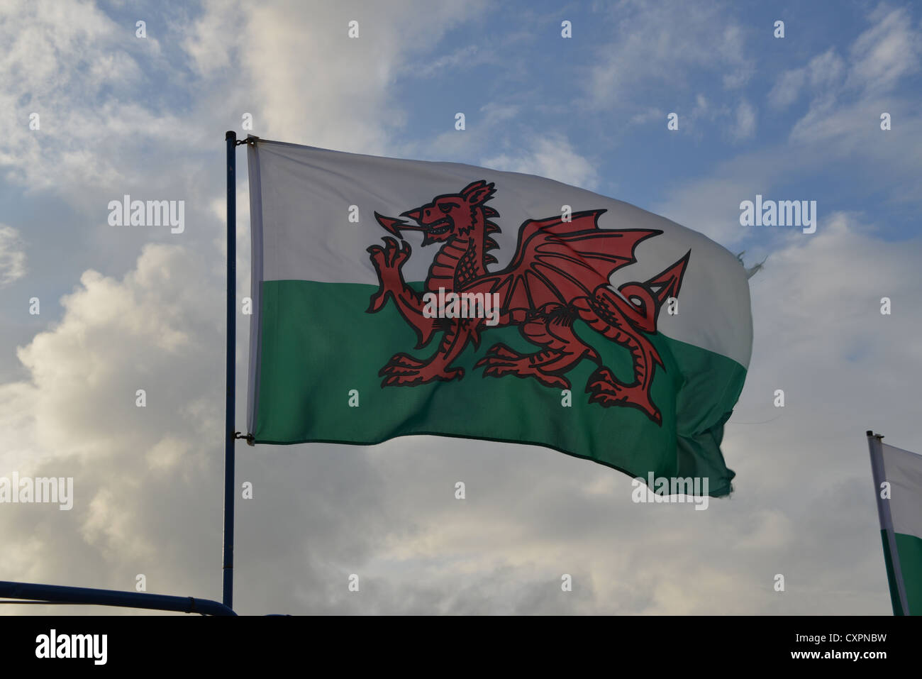 Welsh flag flying against blue sky Stock Photo - Alamy