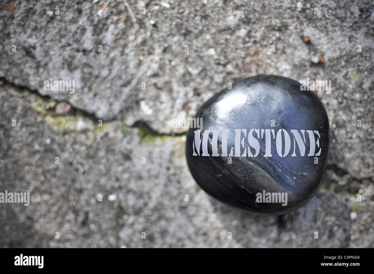 Milestone printed on a pebble rock Stock Photo - Alamy
