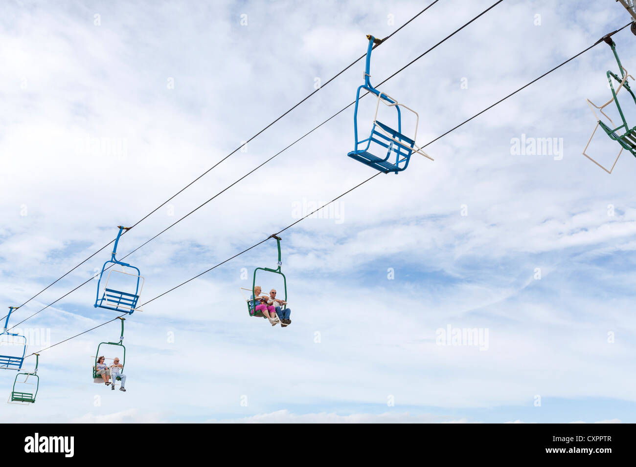 Riders enjoying an Amusement Park Ski Lift Ride Stock Photo - Alamy