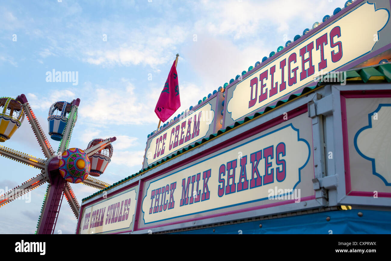 A ferris wheel and an ice cream shop in an amusement park on an ocean ...