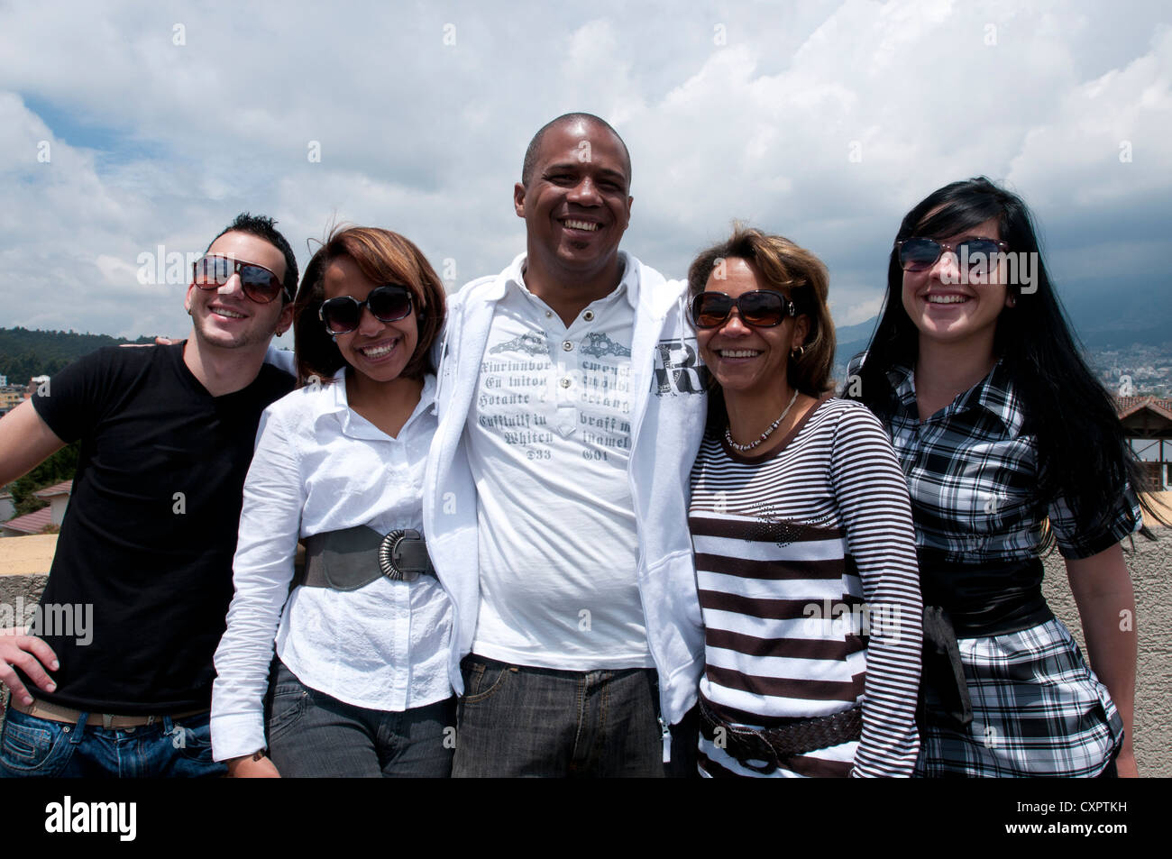 Group of friends gathered on the roof of a building Stock Photo - Alamy