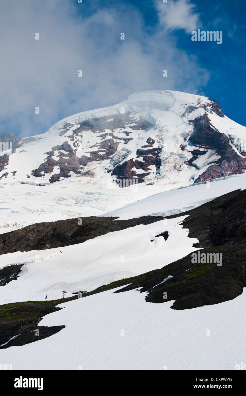 Climbers walk along the base of the volcano Mt. Baker, Washington ...