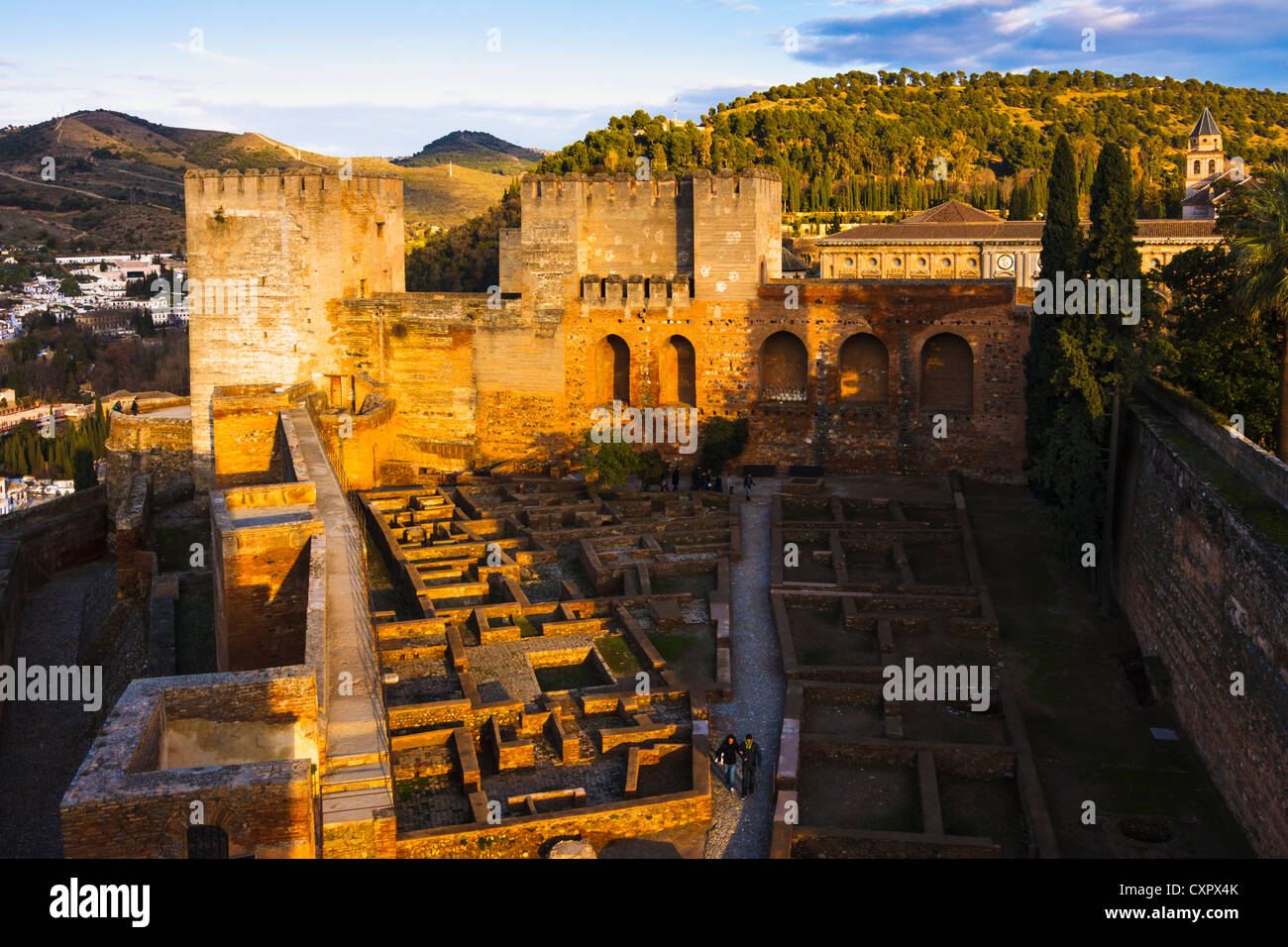 A couple walks through the Alcazaba fort section of the Alhambra palace ...