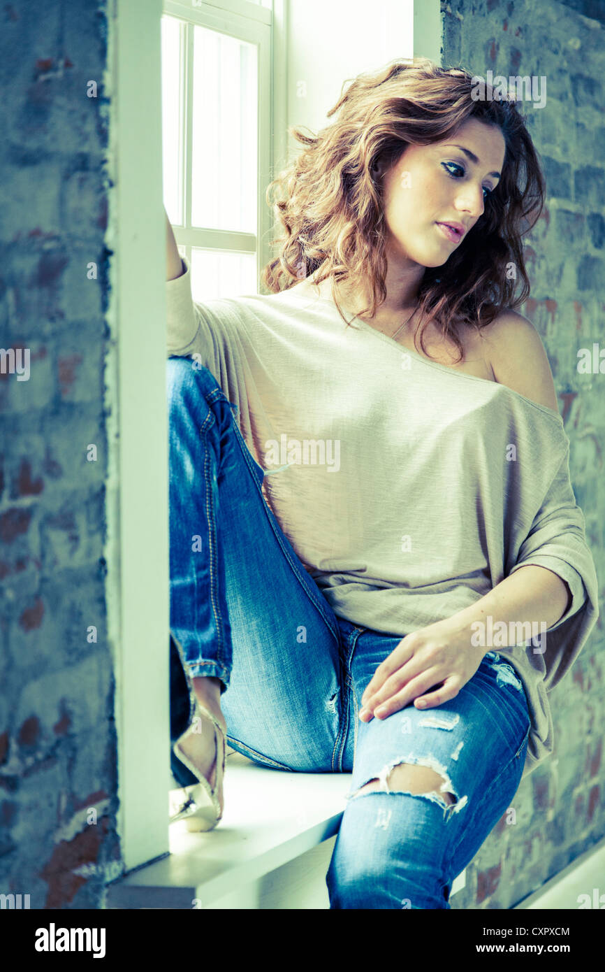 Young woman by the window Stock Photo - Alamy