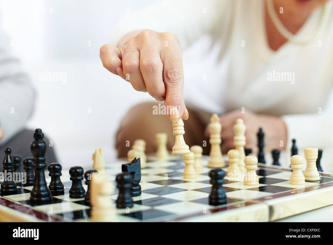 Portrait of senior human hand holding chess figure Stock Photo - Alamy