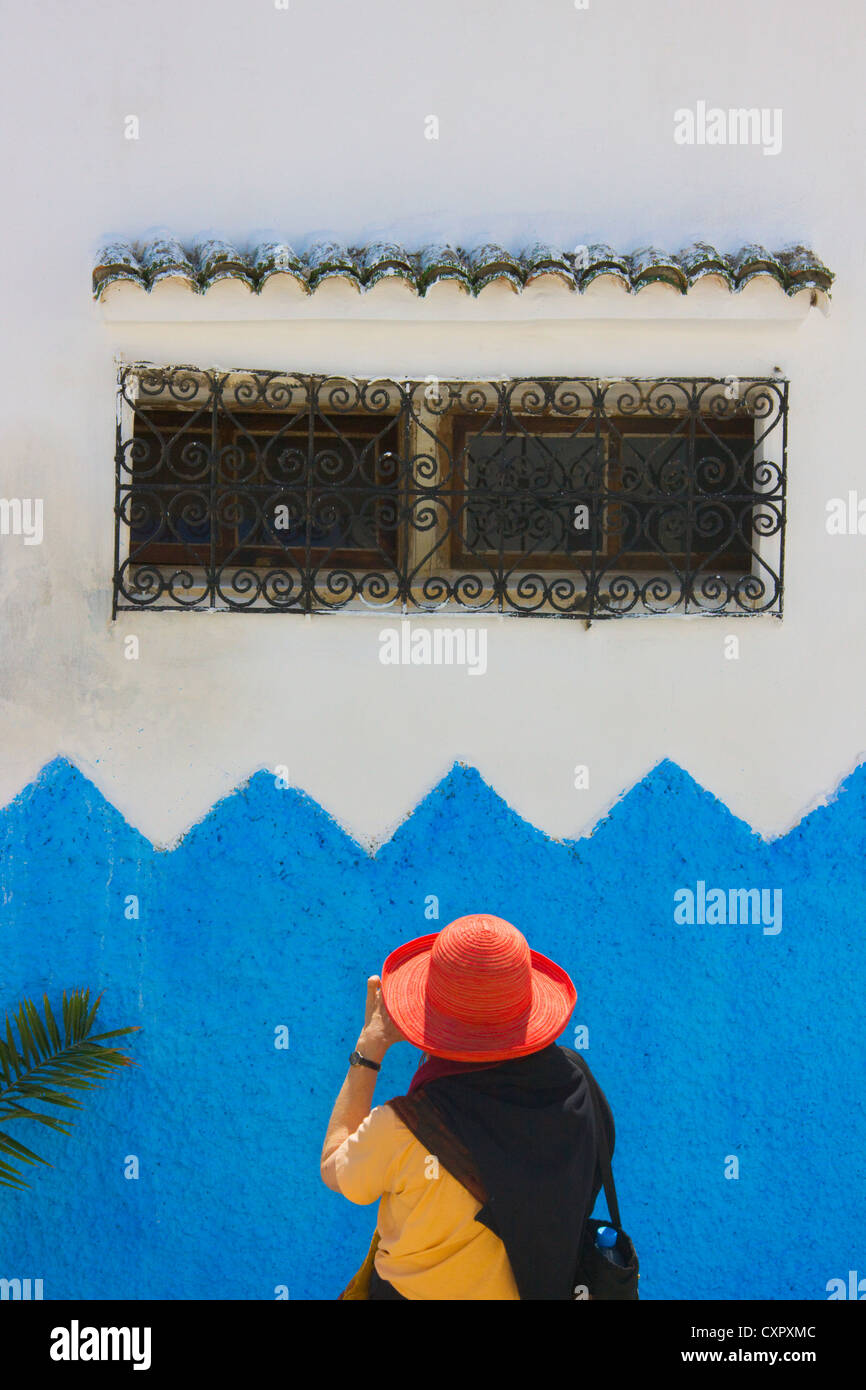 Tourist photographing traditional house in the medina, Rabat, Morocco ...