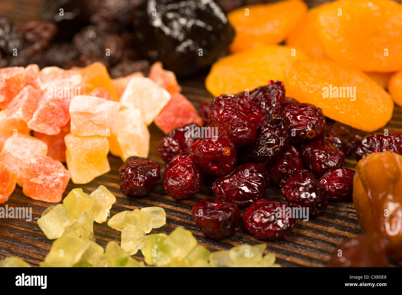 Assorted dried fruit displayed on an wooden surface Stock Photo - Alamy
