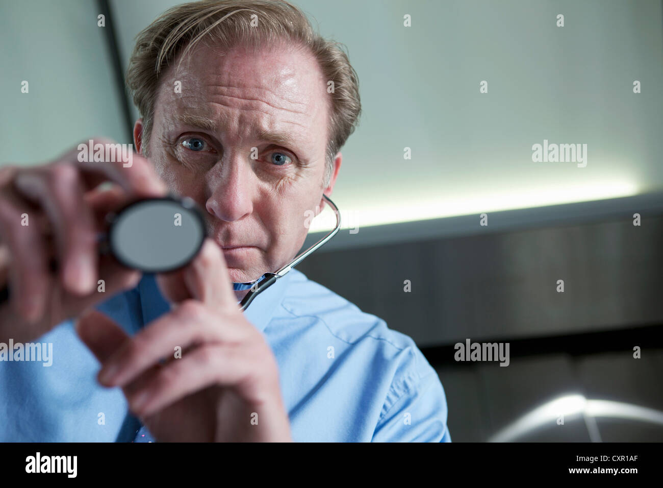 Doctor using stethoscope, personal perspective Stock Photo - Alamy