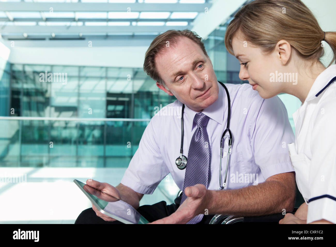 Doctor and nurse with medical records on digital tablet Stock Photo - Alamy