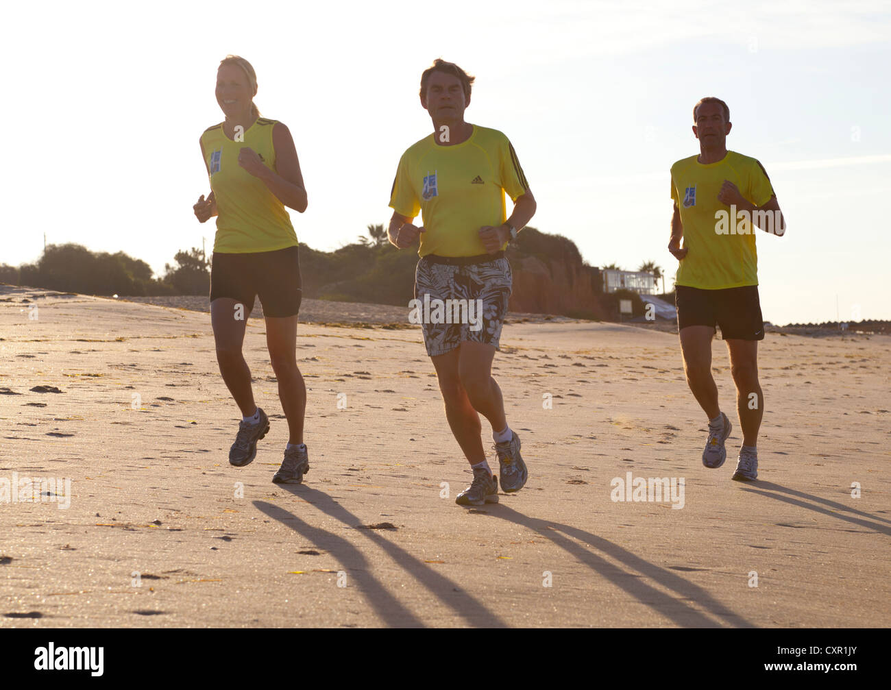 Joggers at beach hi-res stock photography and images - Alamy