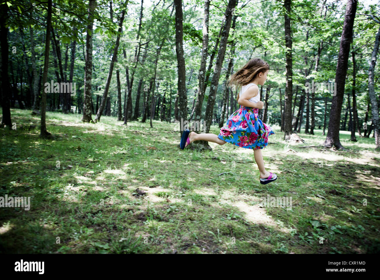 Girl running in forest Stock Photo - Alamy