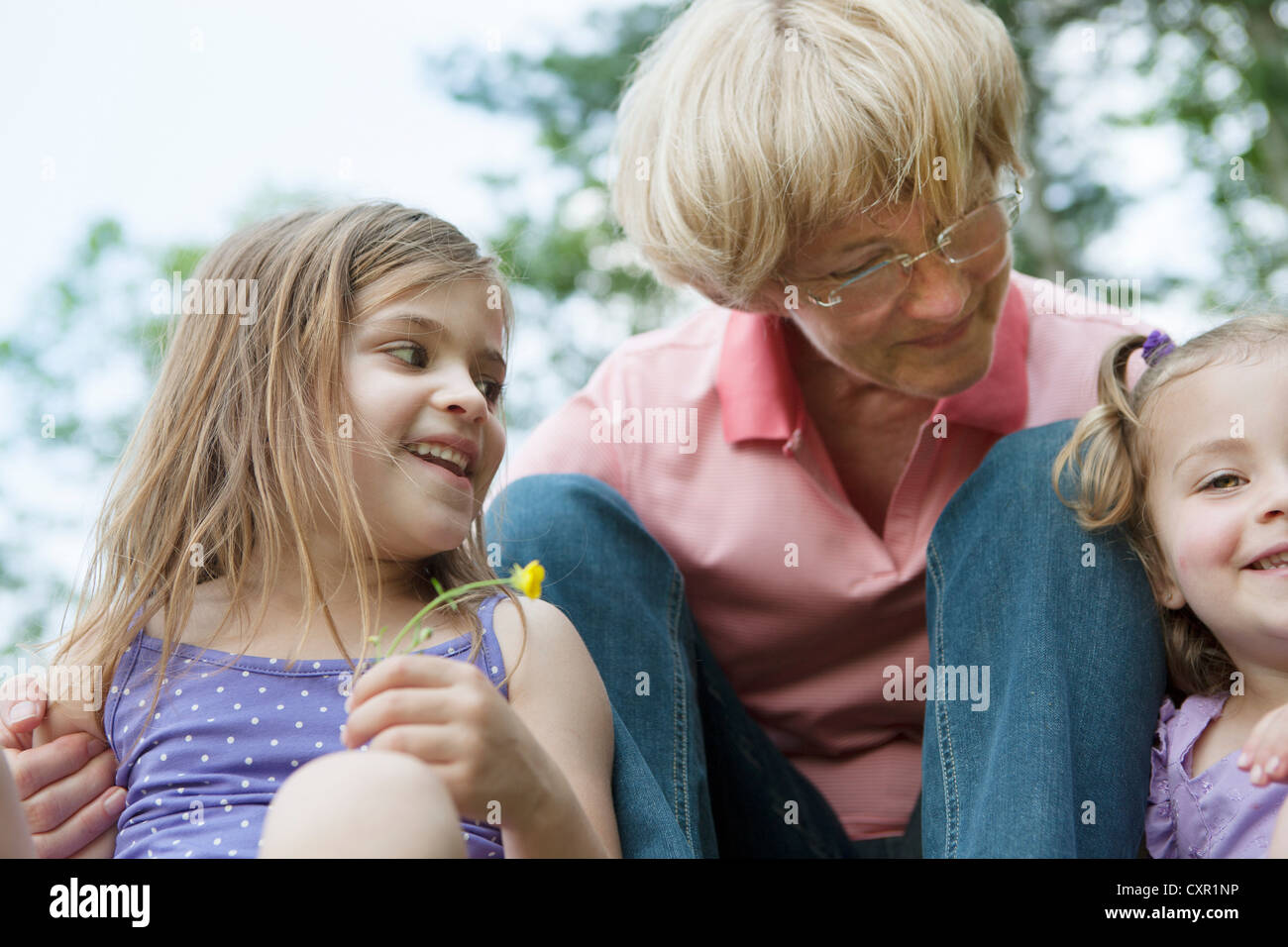 Grandmother with two granddaughters Stock Photo - Alamy