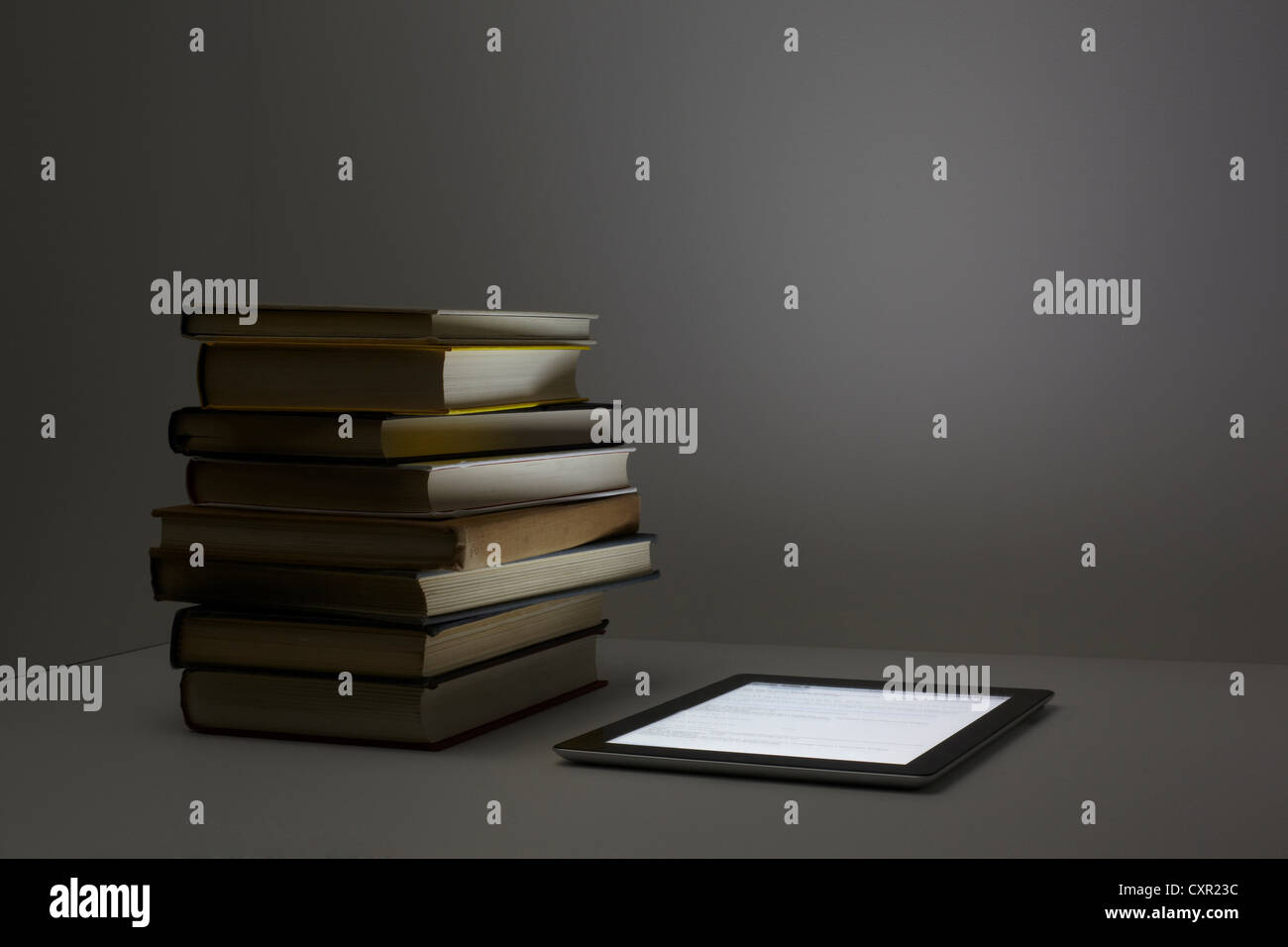 Stack of books with digital tablet Stock Photo - Alamy