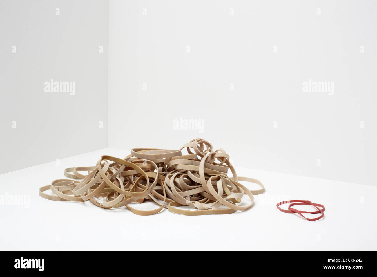 Stack of rubber bands with two red rubber bands Stock Photo - Alamy