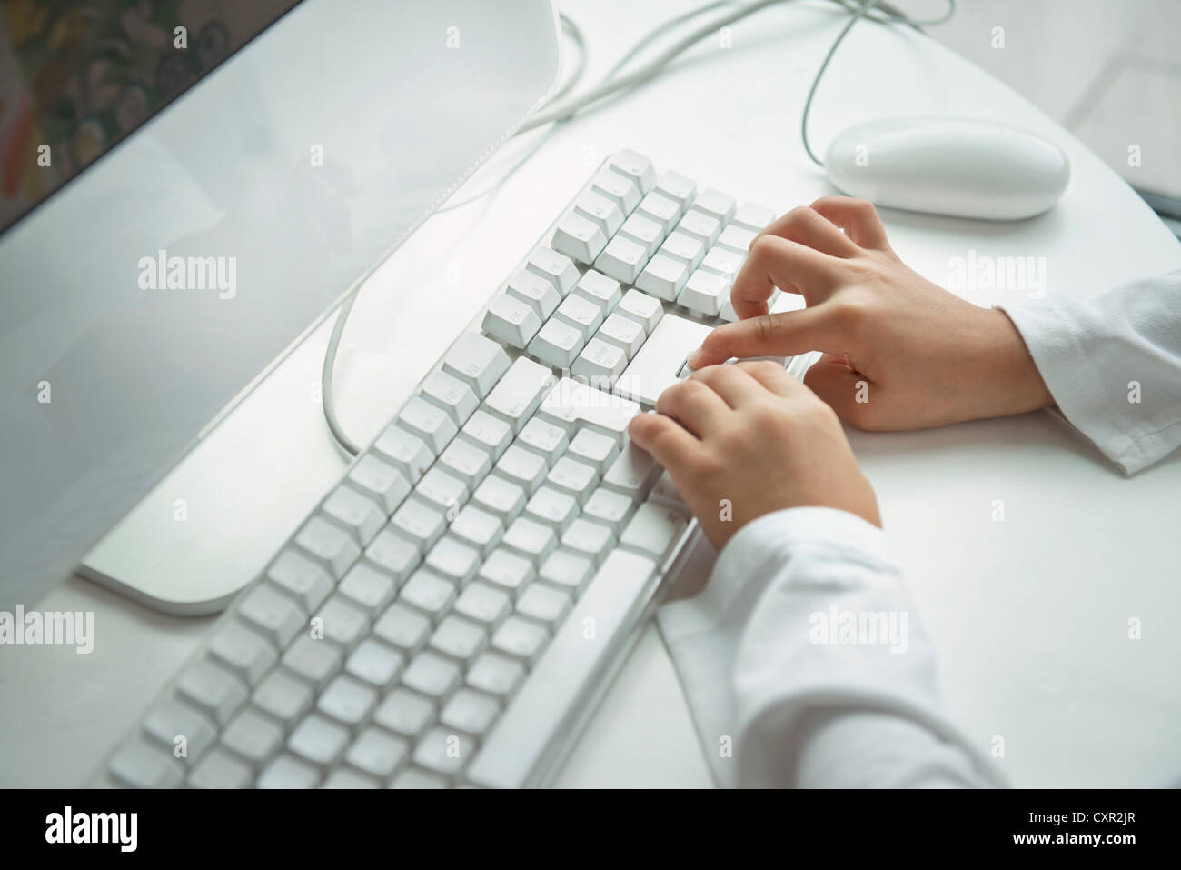 Child typing on computer keyboard Stock Photo - Alamy