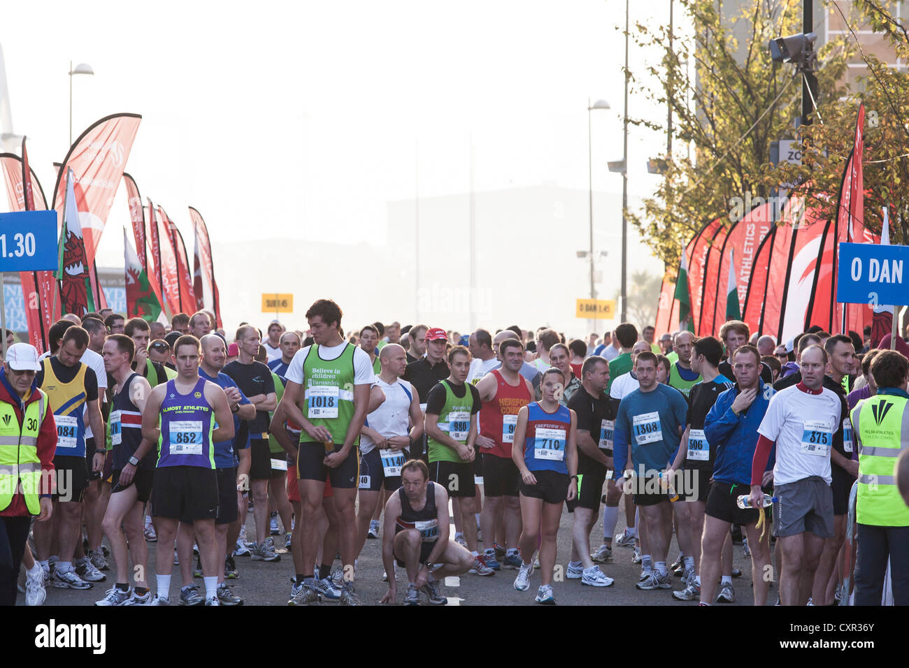 The elite runners wait at the start line for the beginning of the ...