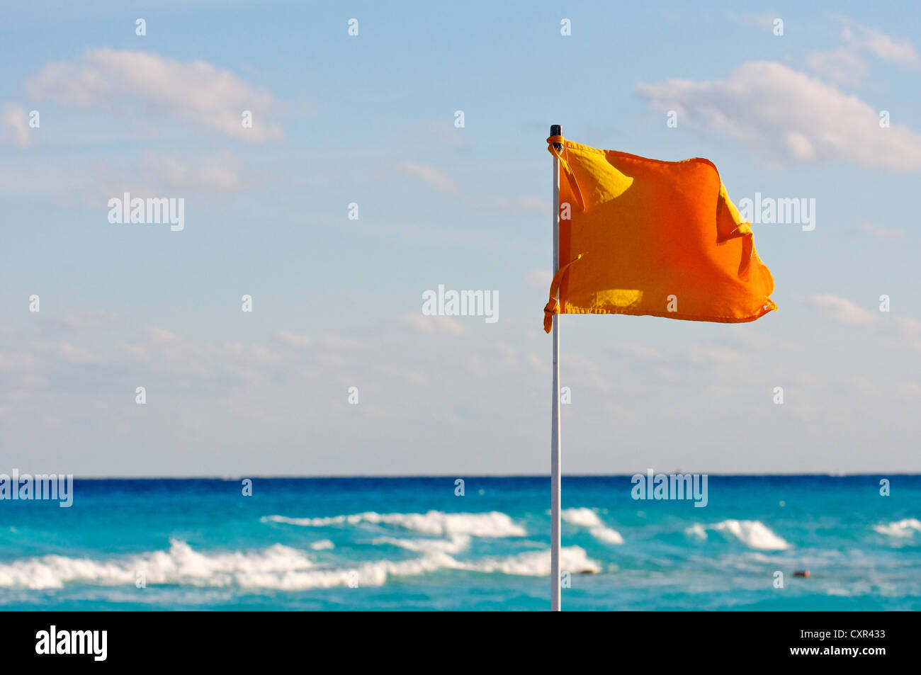 Yellow lifeguard flag over turquoise blue ocean surf Stock Photo - Alamy