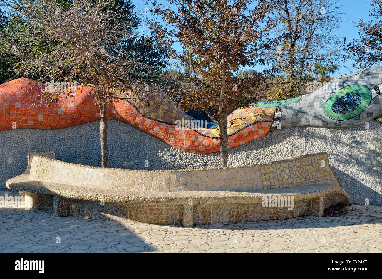 Bench in front of the enclosure wall with a mythological serpent ...