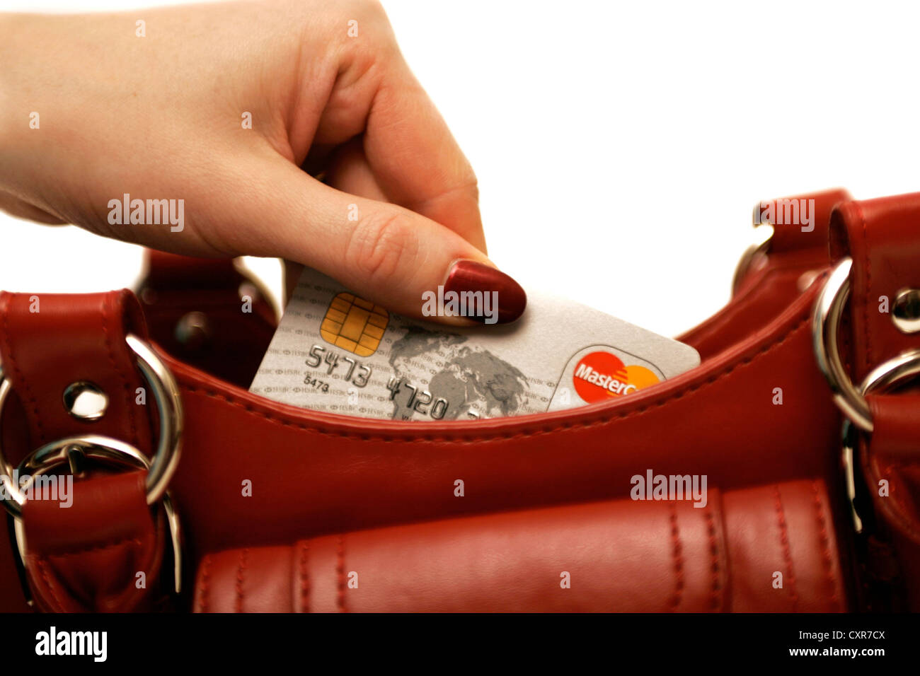Ladies hand pulling credit card coming out of handbag with red painted nails Stock Photo - Alamy