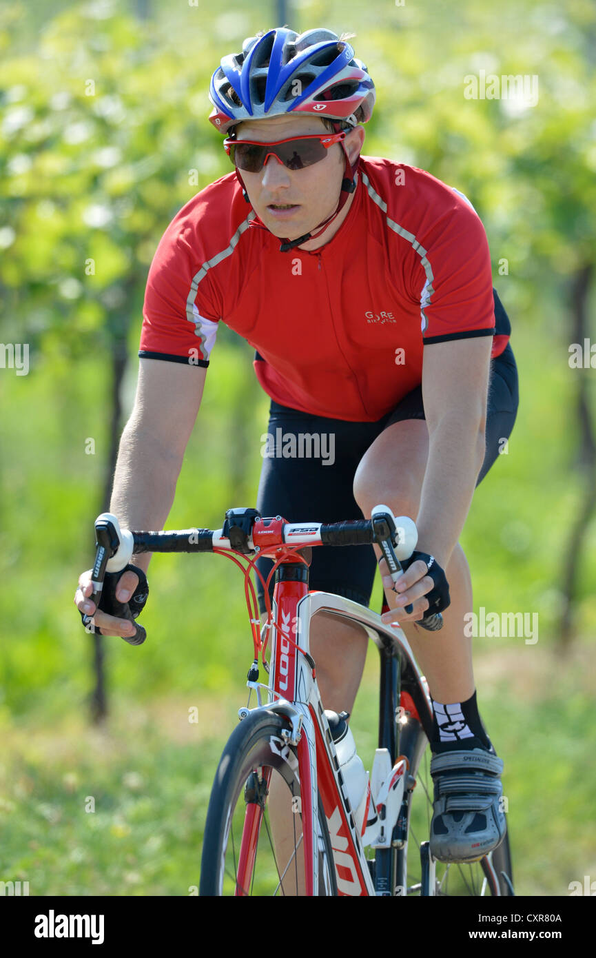 Cyclist riding a high-quality carbon road bike, Weinstadt, Baden ...