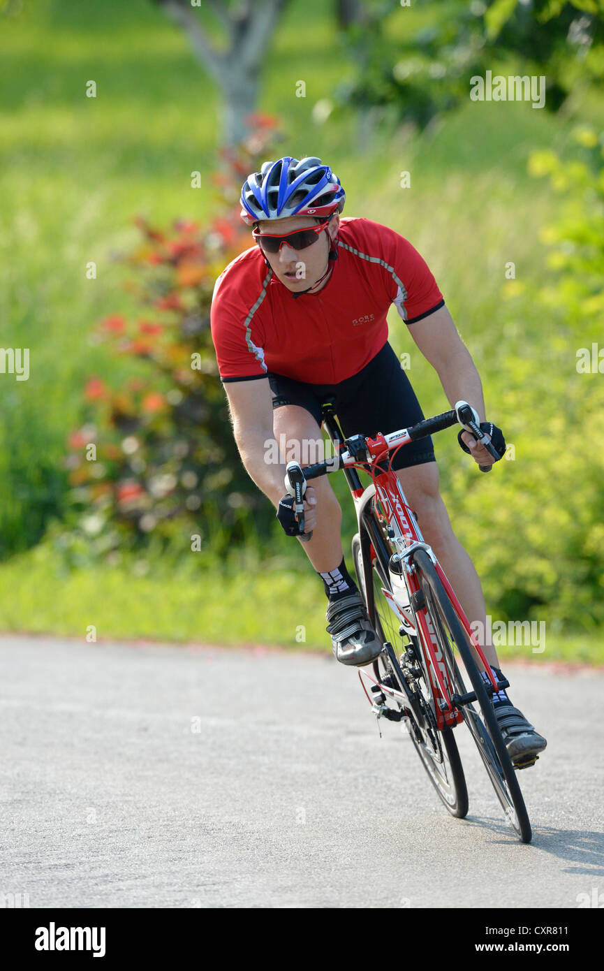 Cyclist riding a high-quality carbon road bike, Weinstadt, Baden ...