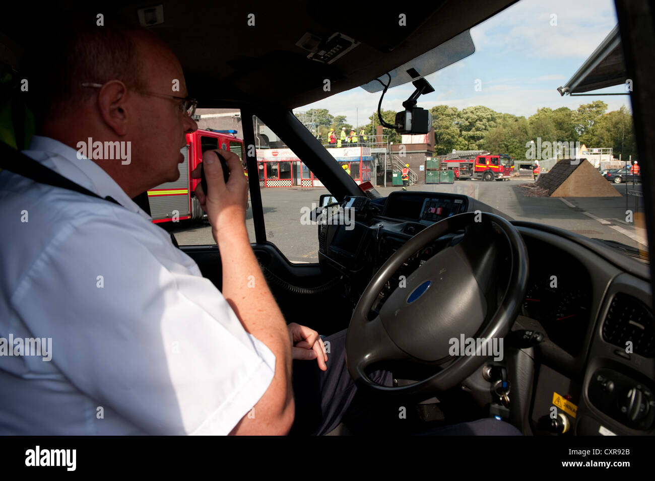 Fire & Rescue Commander on Radio in Vehicle Stock Photo - Alamy