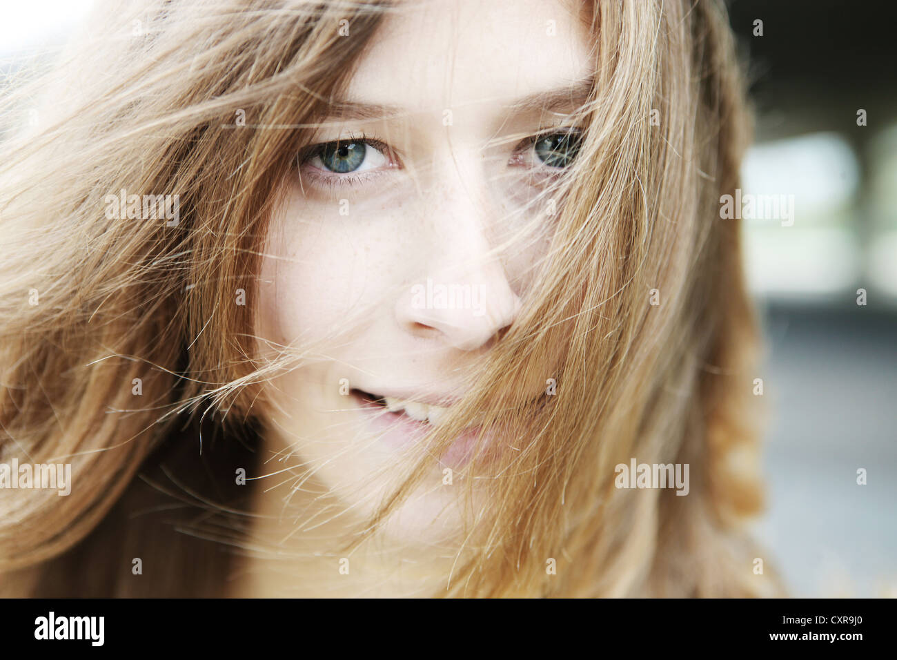 Young woman, hair blowing in the wind, portrait Stock Photo - Alamy