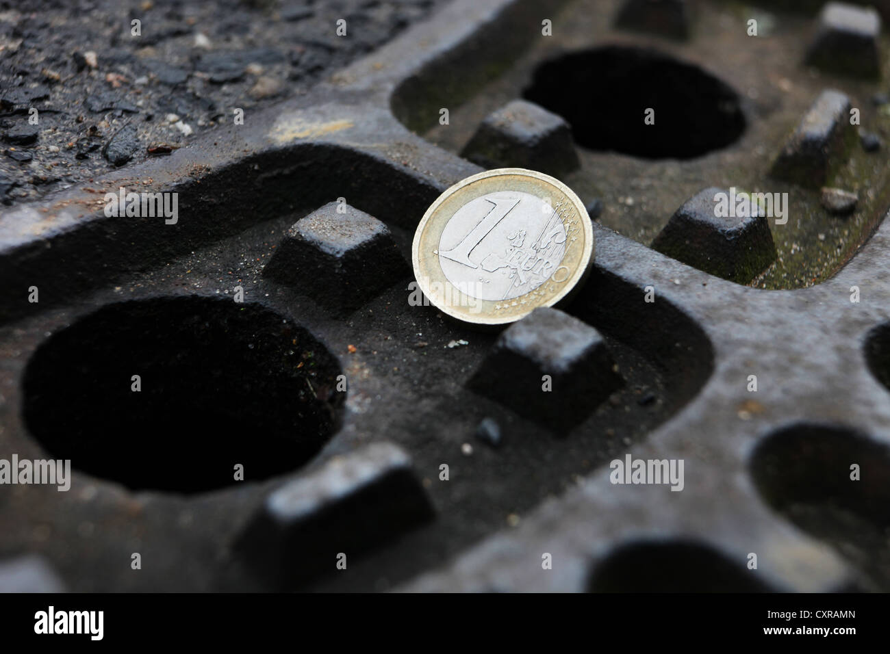 Euro coin, drain Stock Photo - Alamy