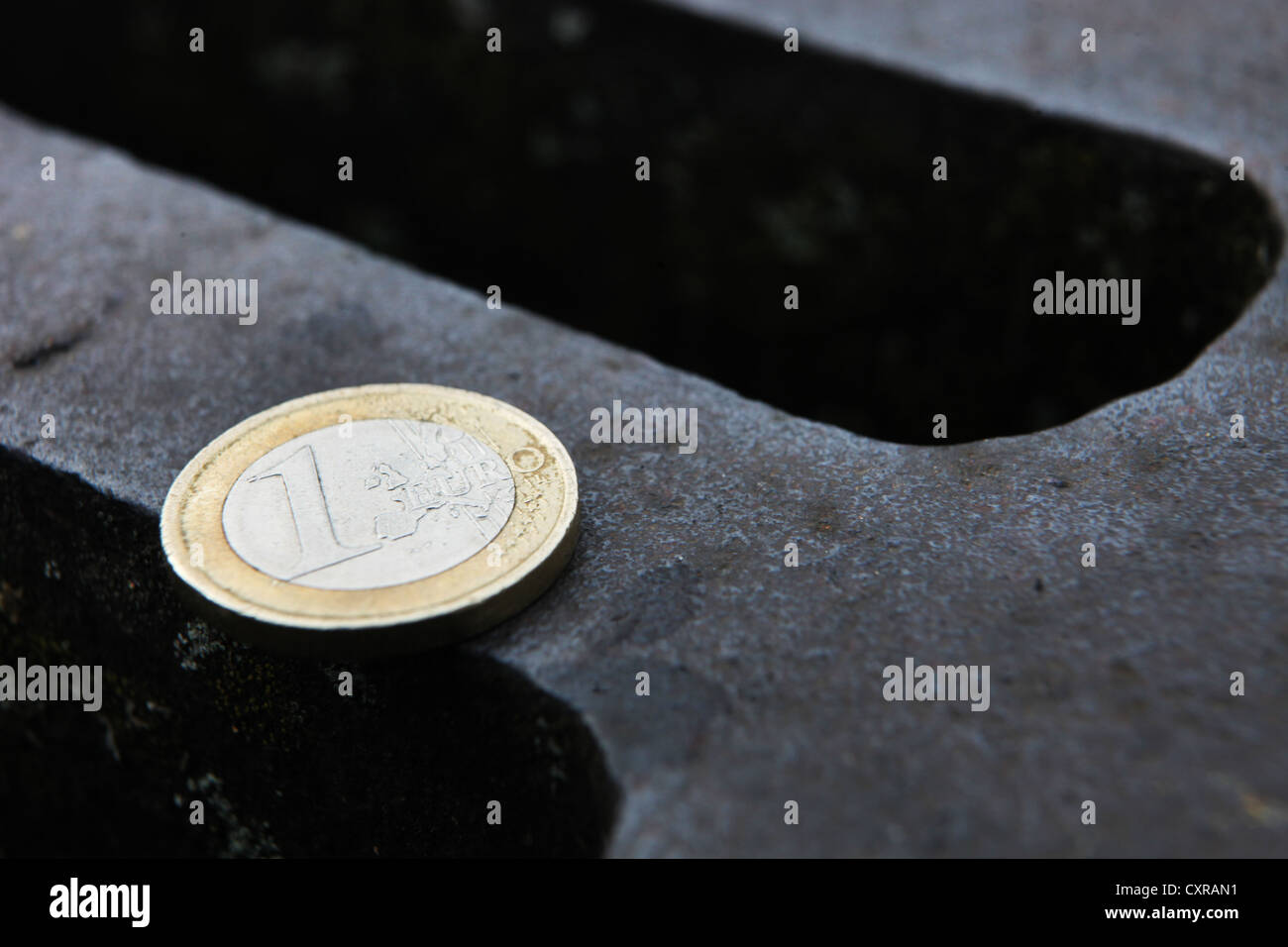 Euro coin, drain Stock Photo - Alamy