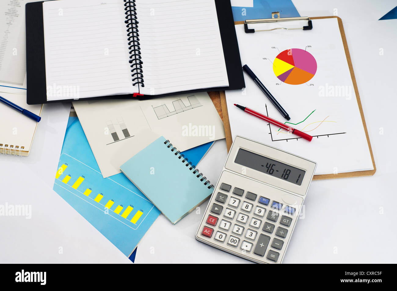 Pen and calculator on paper table with diagram Stock Photo - Alamy
