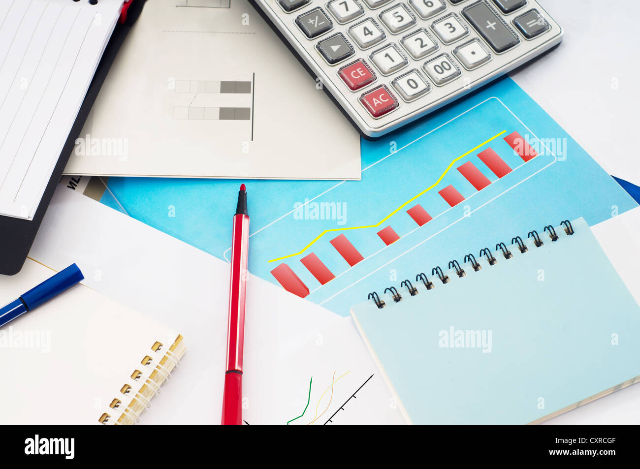 Chart with pen and calculator Stock Photo - Alamy