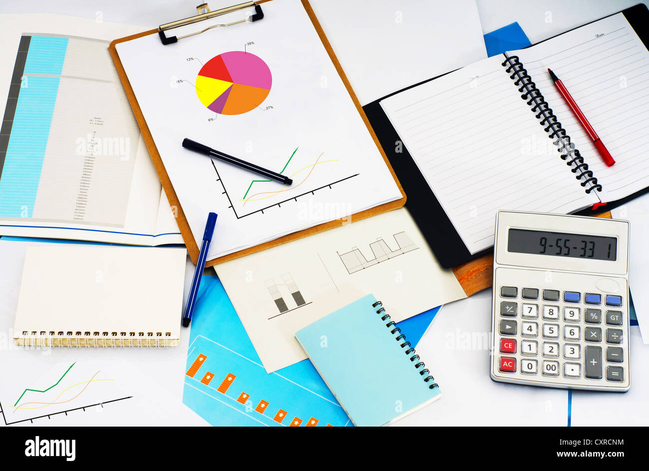 Chart with pen and calculator Stock Photo - Alamy