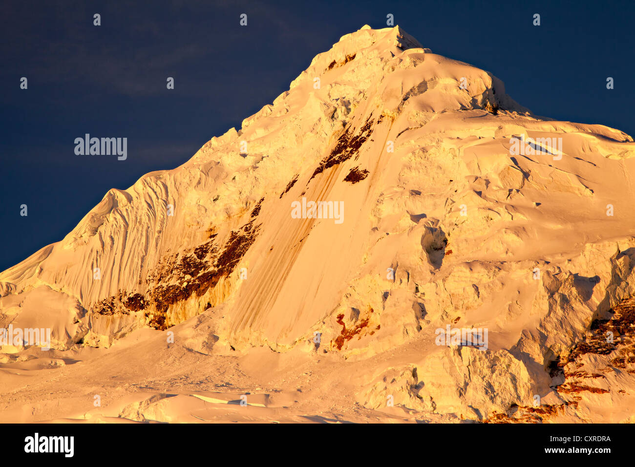 Summit pyramid of Mt Tocllaraju in the evening light, Cordillera Blanca ...