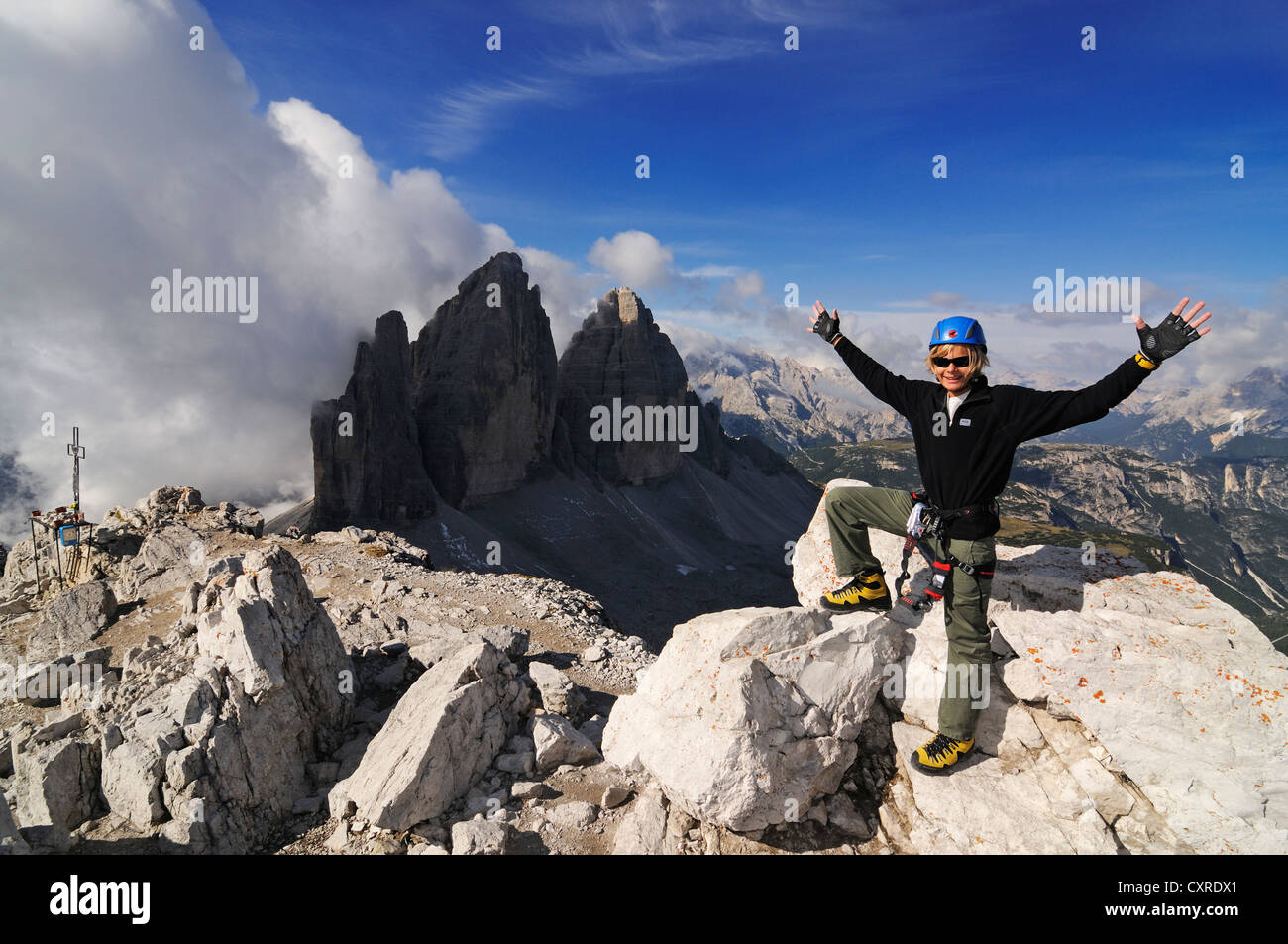 Teenager climbing on the Paternkofel fixed rope route, here standing on ...