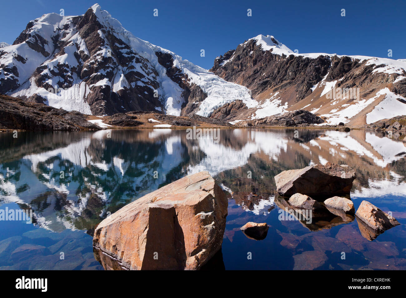 Peaks of the Cordillera Huayhuash mountain range being reflected in a ...