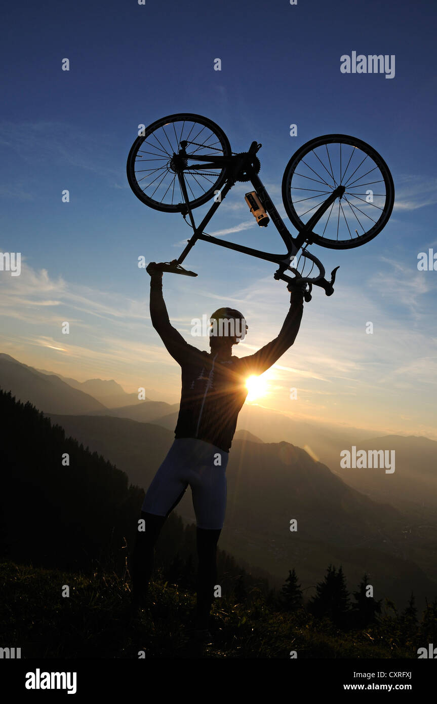 Cyclist holding bike above head hi-res stock photography and images - Alamy