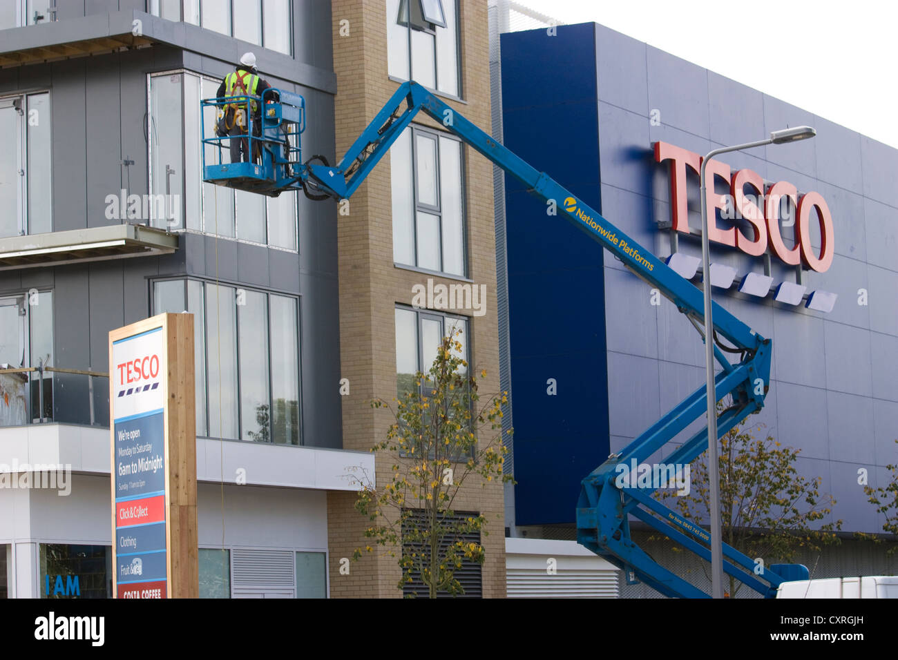 Builders making adjustments to the new Tesco supermarket store in ...